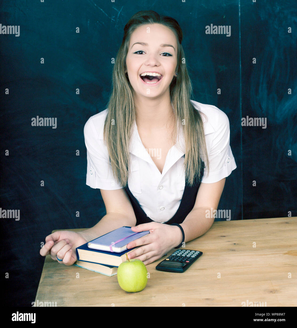 portrait of happy cute student in classroom at blackboard back to ...