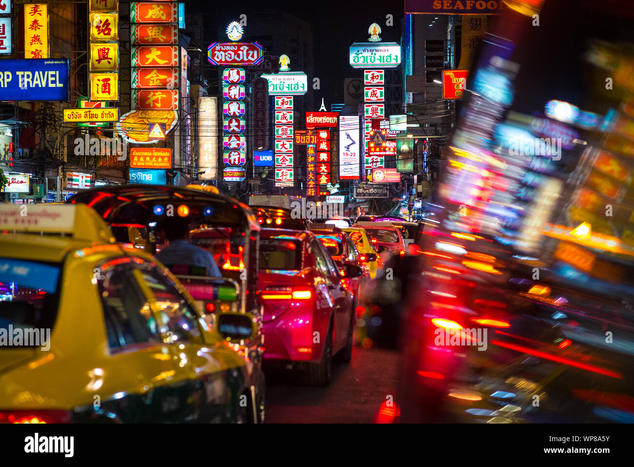 Bangkok - June 13, 2019: Yaowarat Road at night, its colorful neon sign boards and street ...