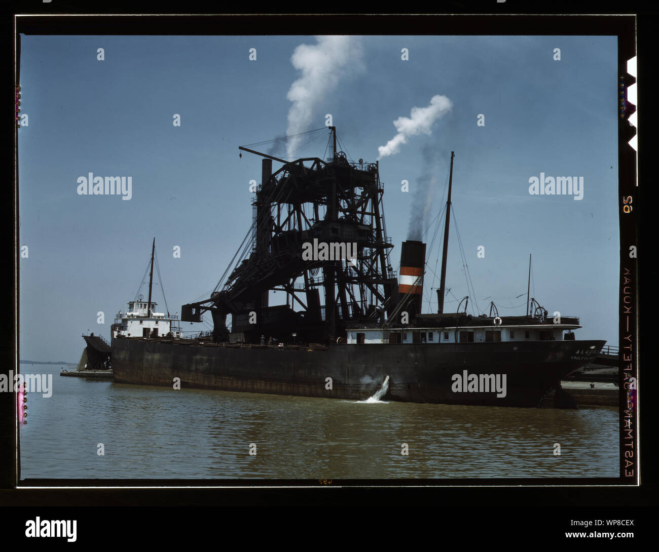 Loading coal into a freighter at one of the Pennsylvania Railroad docks ...