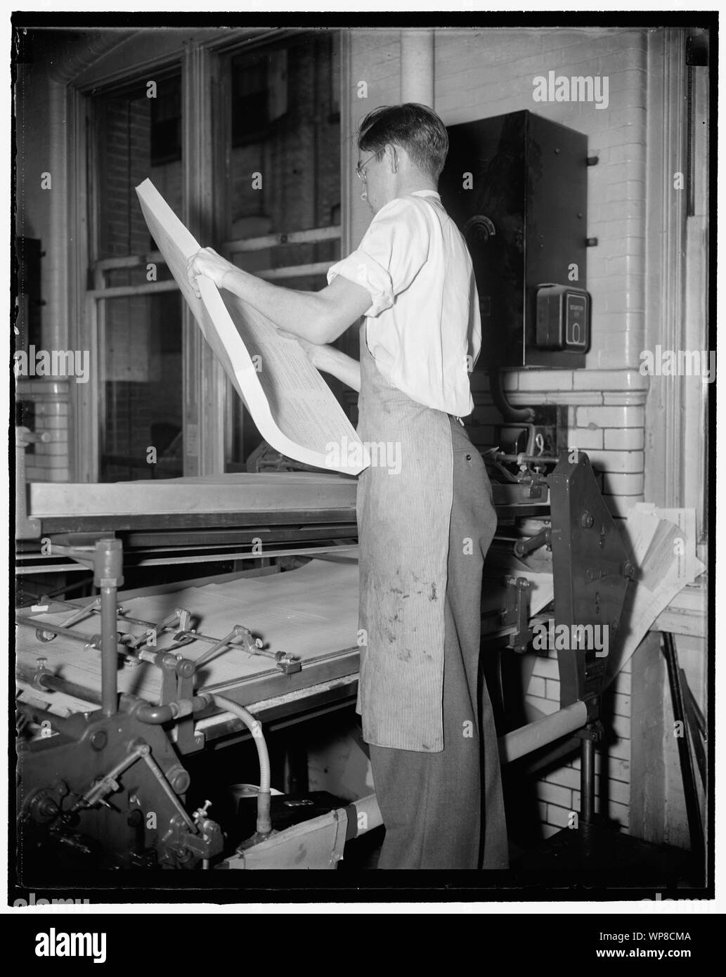 Loading the folding machine Stock Photo - Alamy