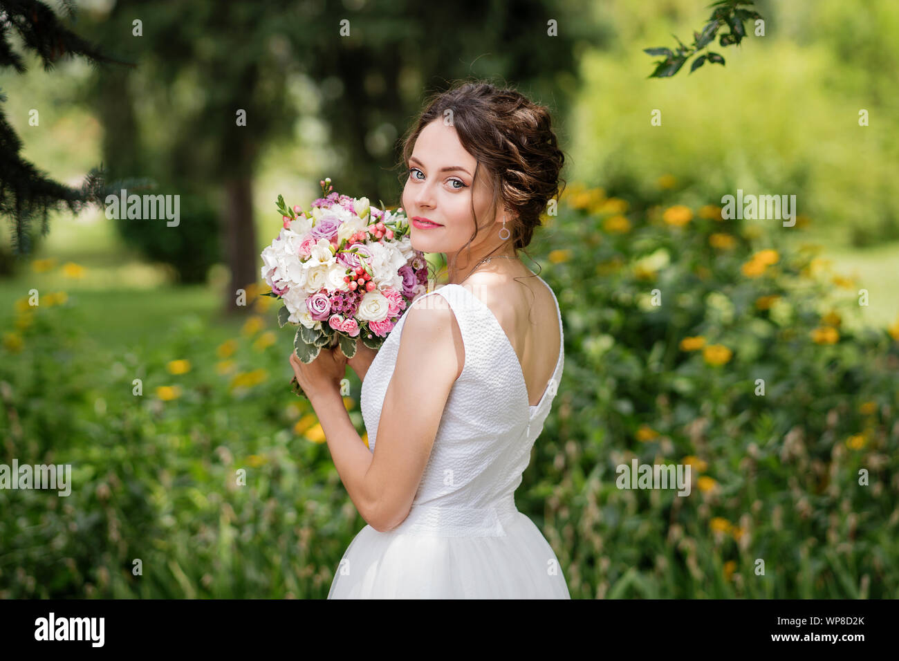 Beautiful bride in fashion wedding dress on natural background. The ...