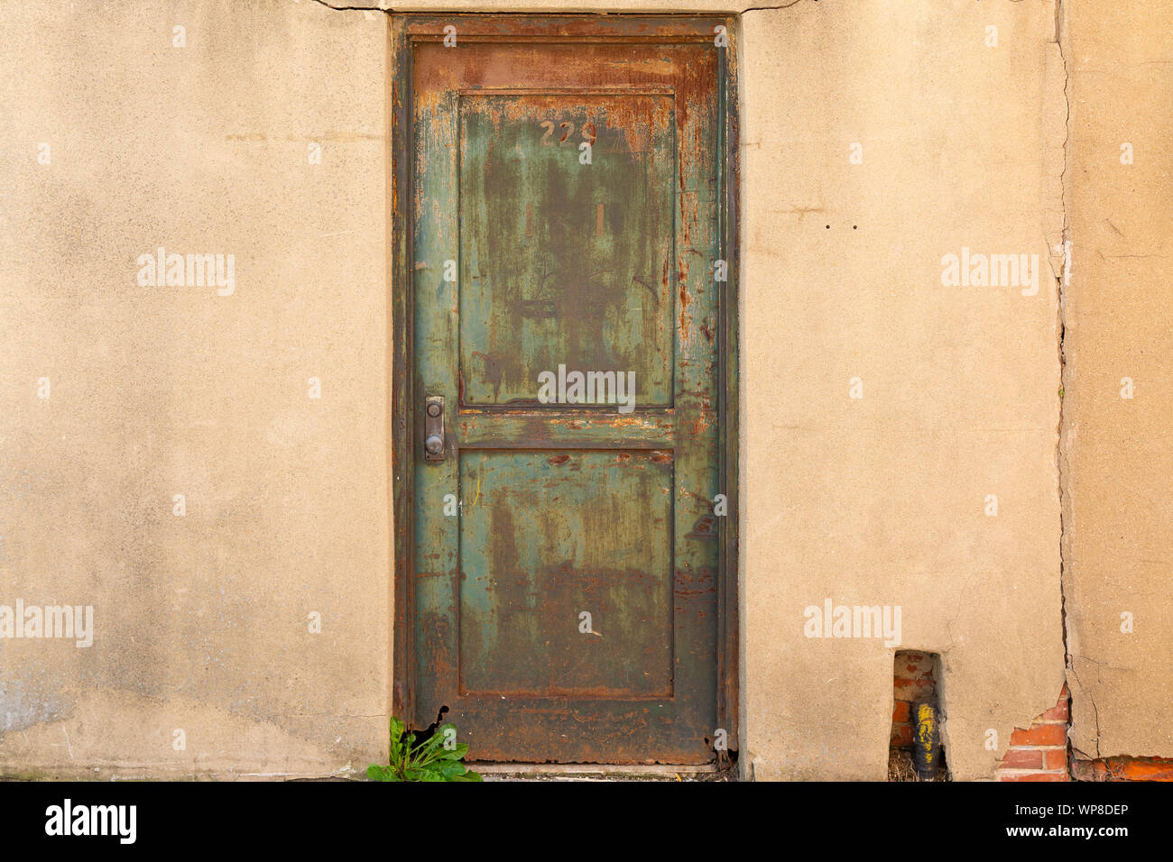 Old rusty door in back alley Stock Photo - Alamy