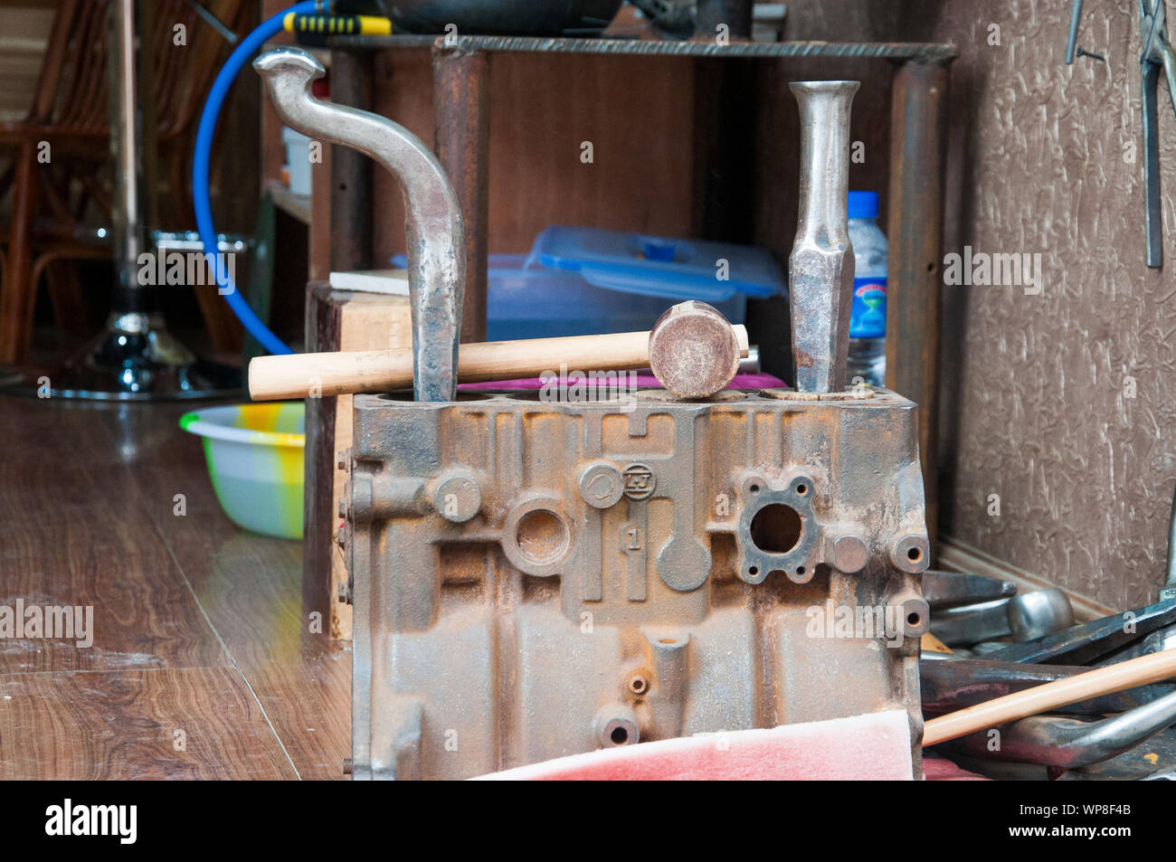 Engine block recycled as an anvil at a workshop in Lijiang, Yunnan ...