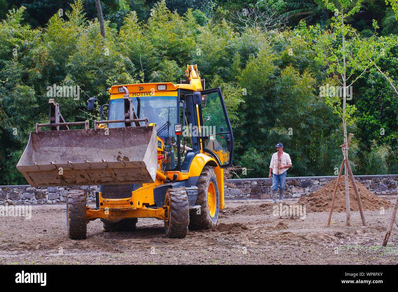 Machinery and workers in small construction site at the Azores islands ...