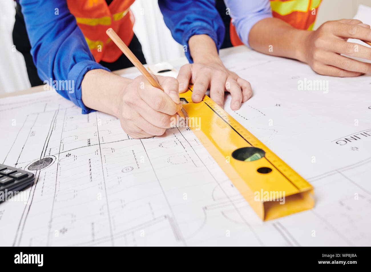 Close-up image of professional engineer using construction level when ...