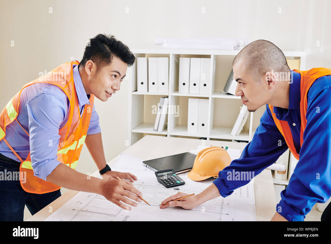 Smiling contractor having discussion hi-res stock photography and ...