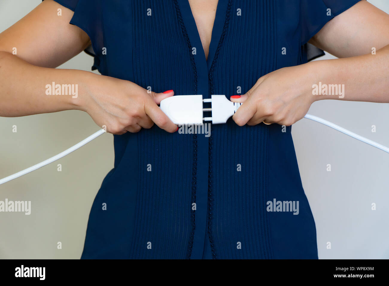 Woman holding two cables hi-res stock photography and images - Alamy