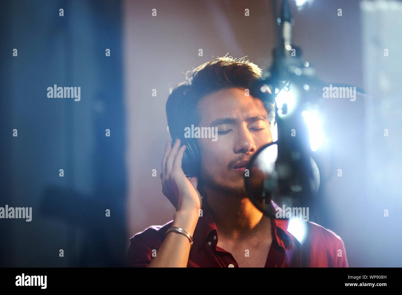 young asian musician singer singing song in recording studio Stock Photo - Alamy