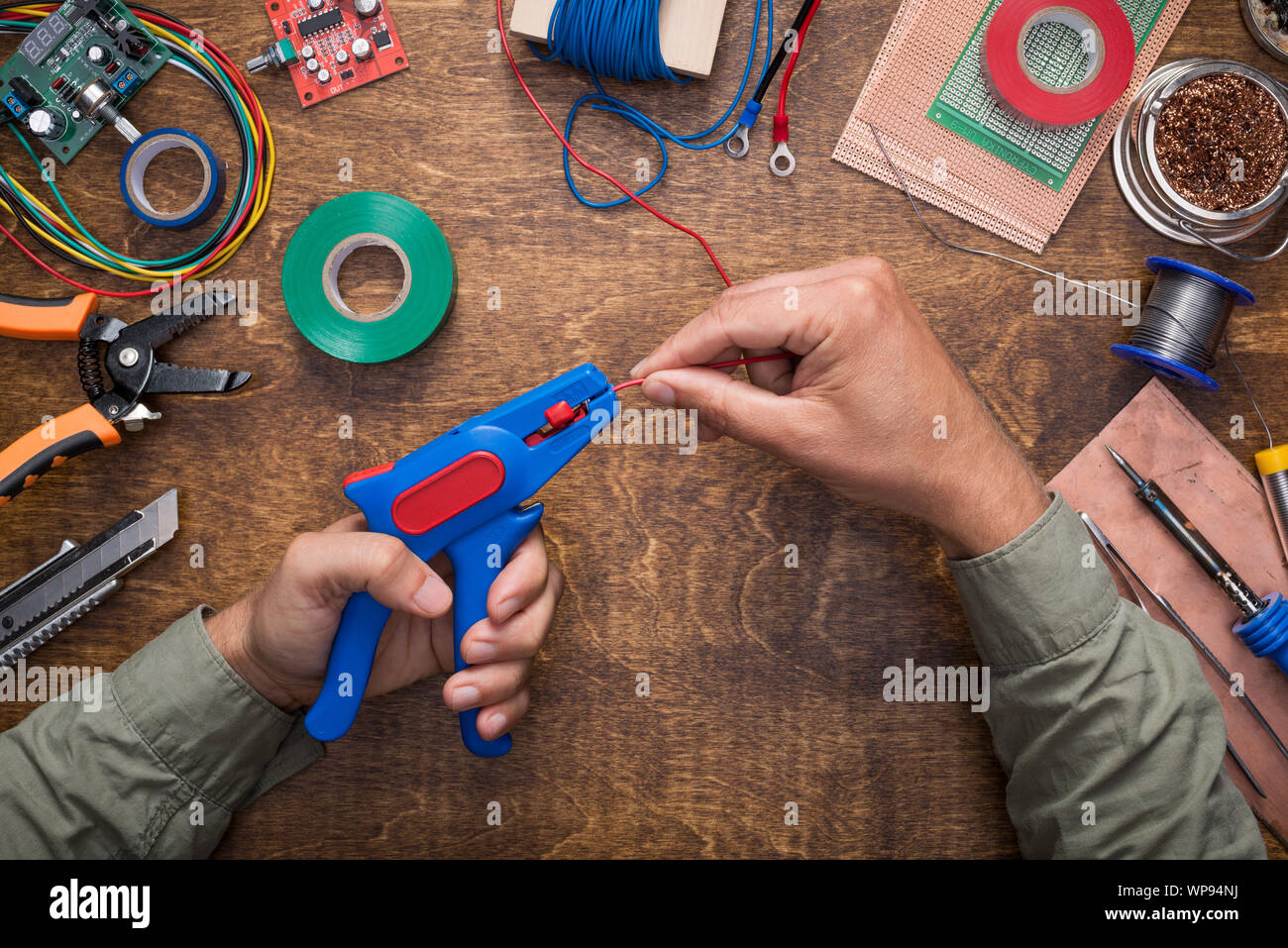 Working with electronics, hands striping wires. DIY, electronics ...