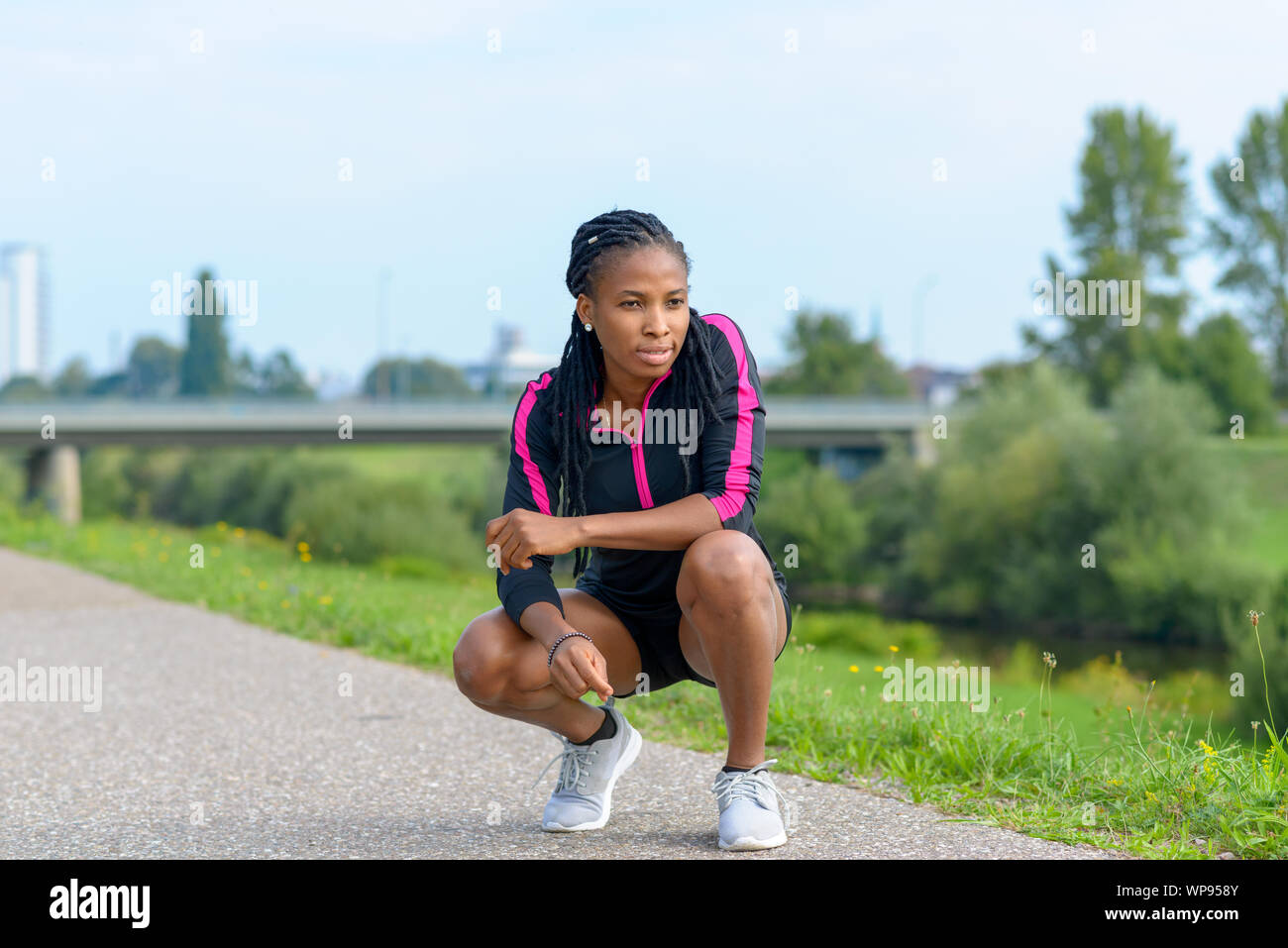Woman crouching squatting young hi-res stock photography and images - Alamy