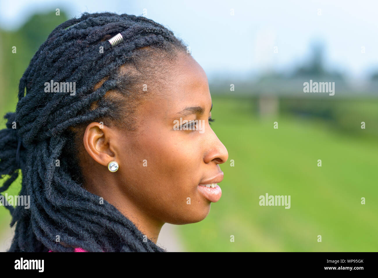 Close up profile of a thoughtful young African woman wearing hair ...