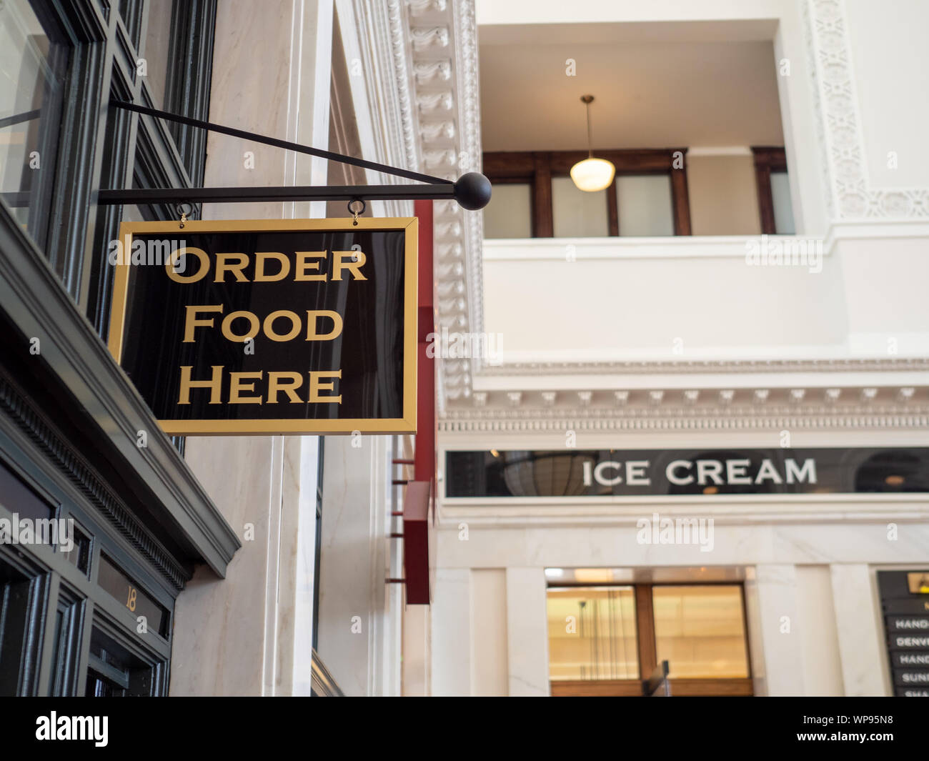 Order food here and ice cream sign posts hanging Stock Photo - Alamy