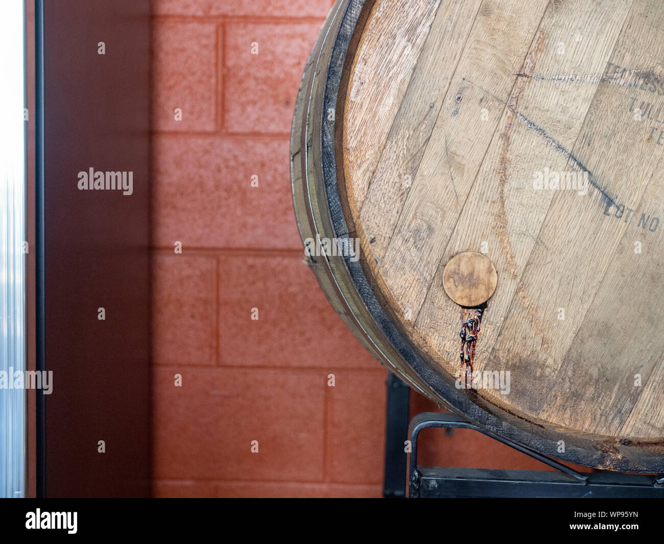 Leaking barrel filled with beer or wine resting in warehouse Stock ...