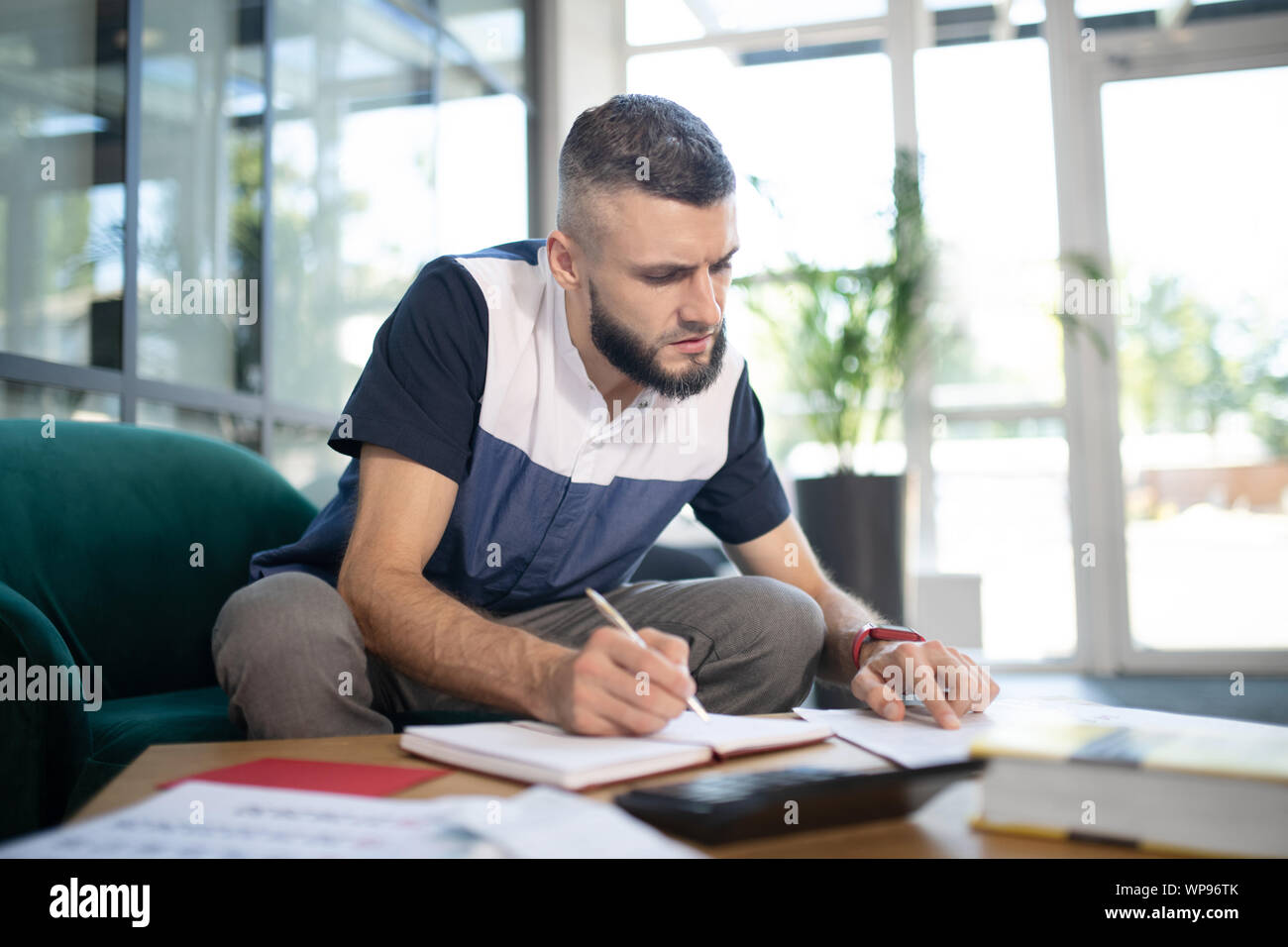 Freelancer feeling busy while working with documents Stock Photo - Alamy