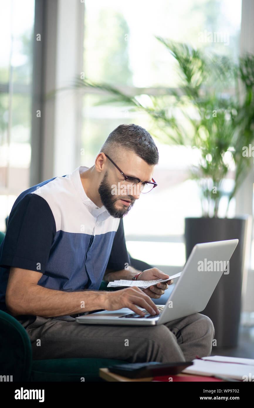 Businessman wearing glasses feeling involved in work Stock Photo - Alamy