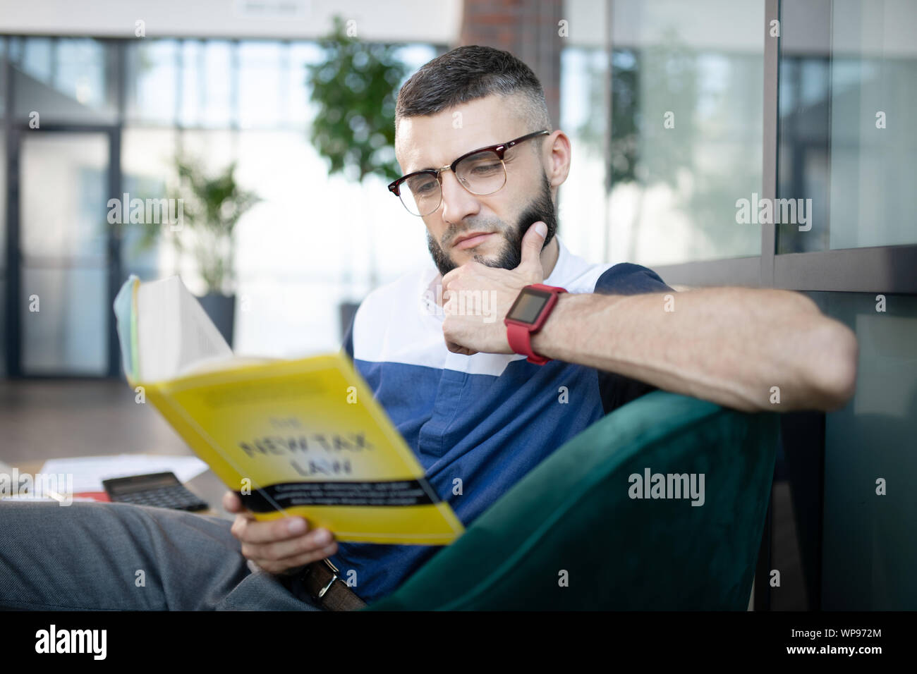 Businessman wearing smart watch feeling busy while reading Stock Photo ...