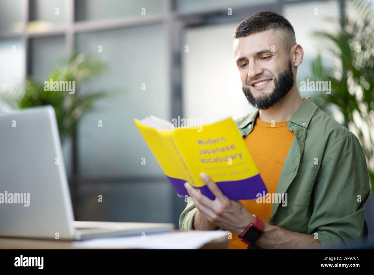 Bearded young man reading and studying foreign language Stock Photo - Alamy
