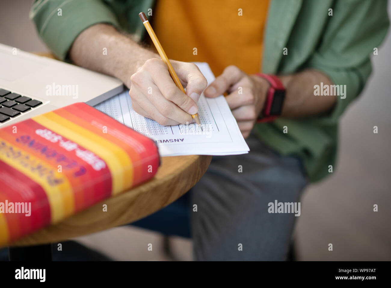 Man holding pencil and making test in foreign language Stock Photo - Alamy