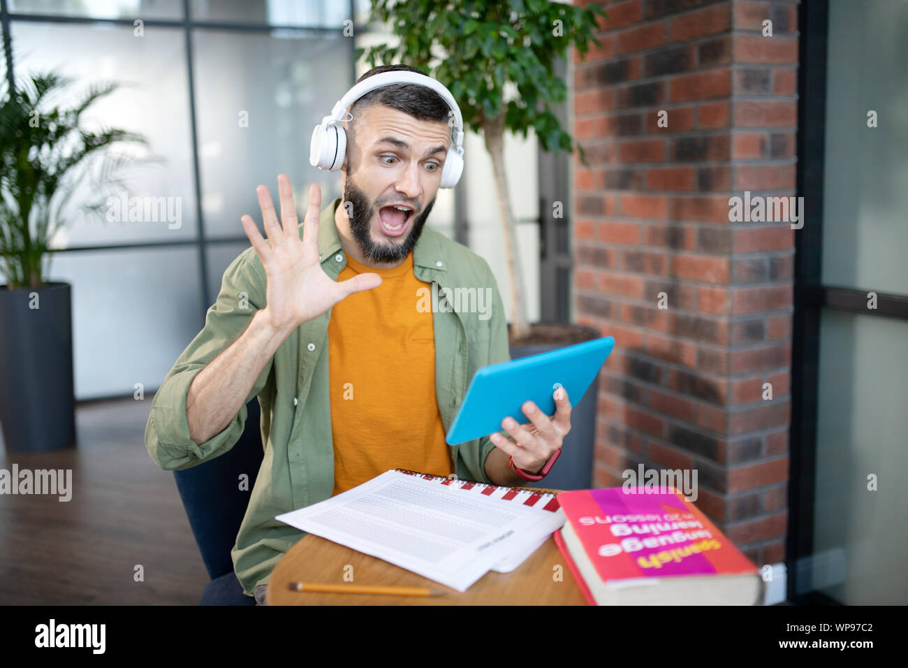 Emotional student having video lesson in foreign language Stock Photo ...
