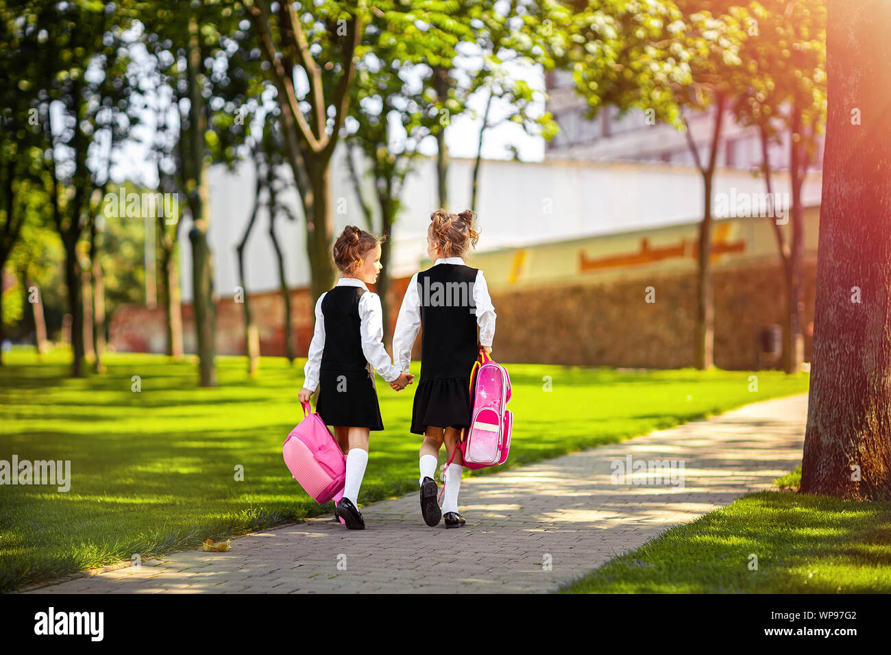 Portrait of happy Caucasian young smiling girls wearing school backpack ...