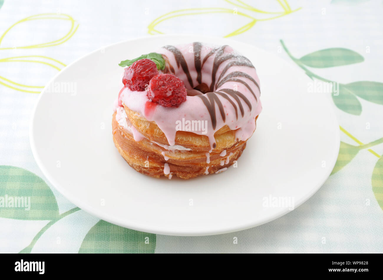 sweet strawberry cake doughnut on a plate isolated on table cloth Stock ...
