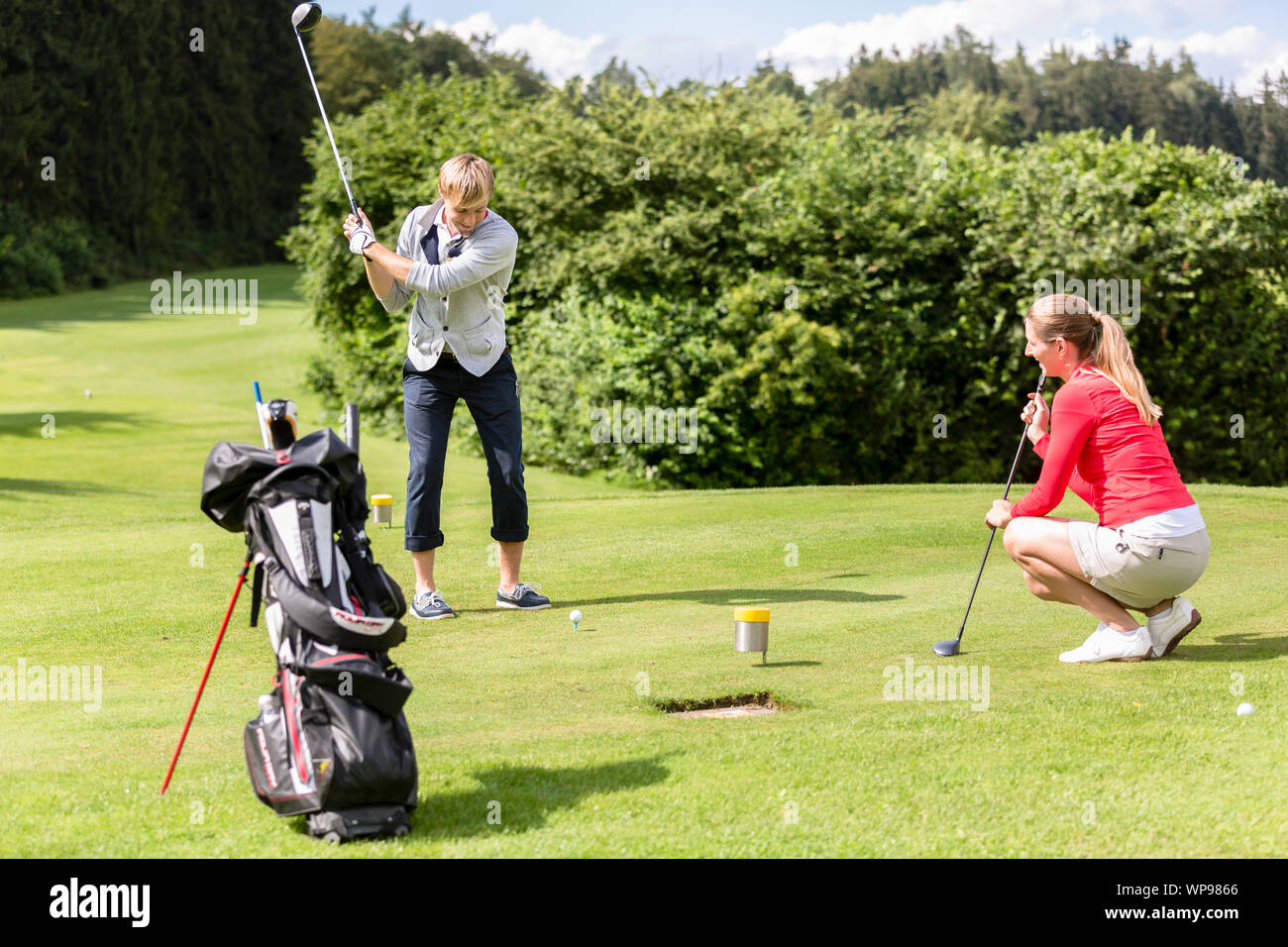 Male golfer putting golf ball on the green golf Stock Photo - Alamy
