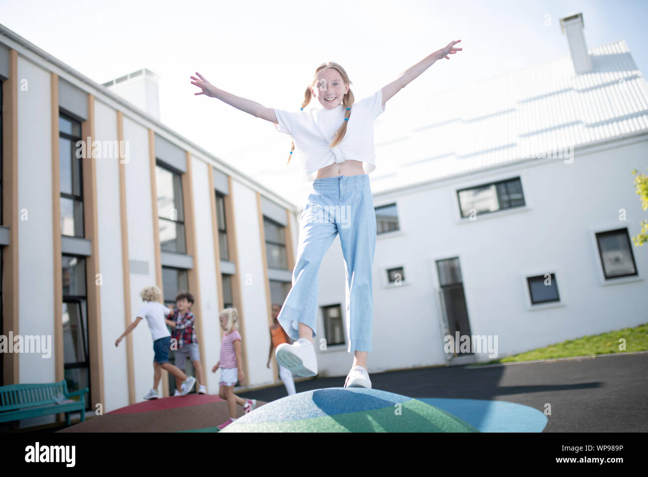 Cheerful schoolgirl playing outside on school break Stock Photo - Alamy