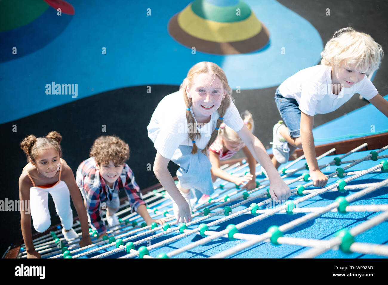 Children feeling involved in climbing all together Stock Photo - Alamy