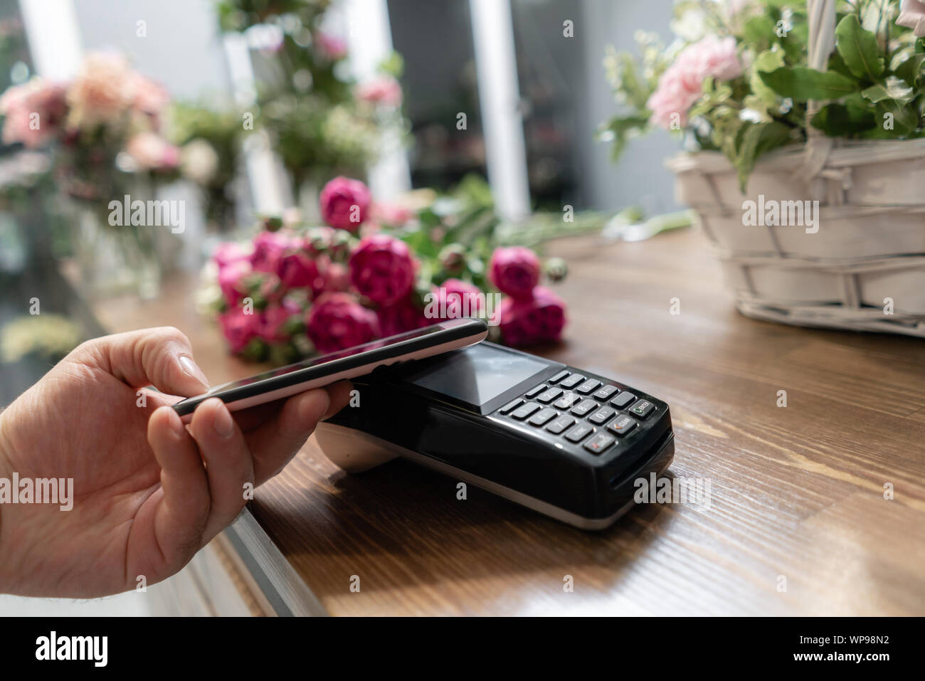 Concept contactless payment. Making payment with smartphone and pos ...