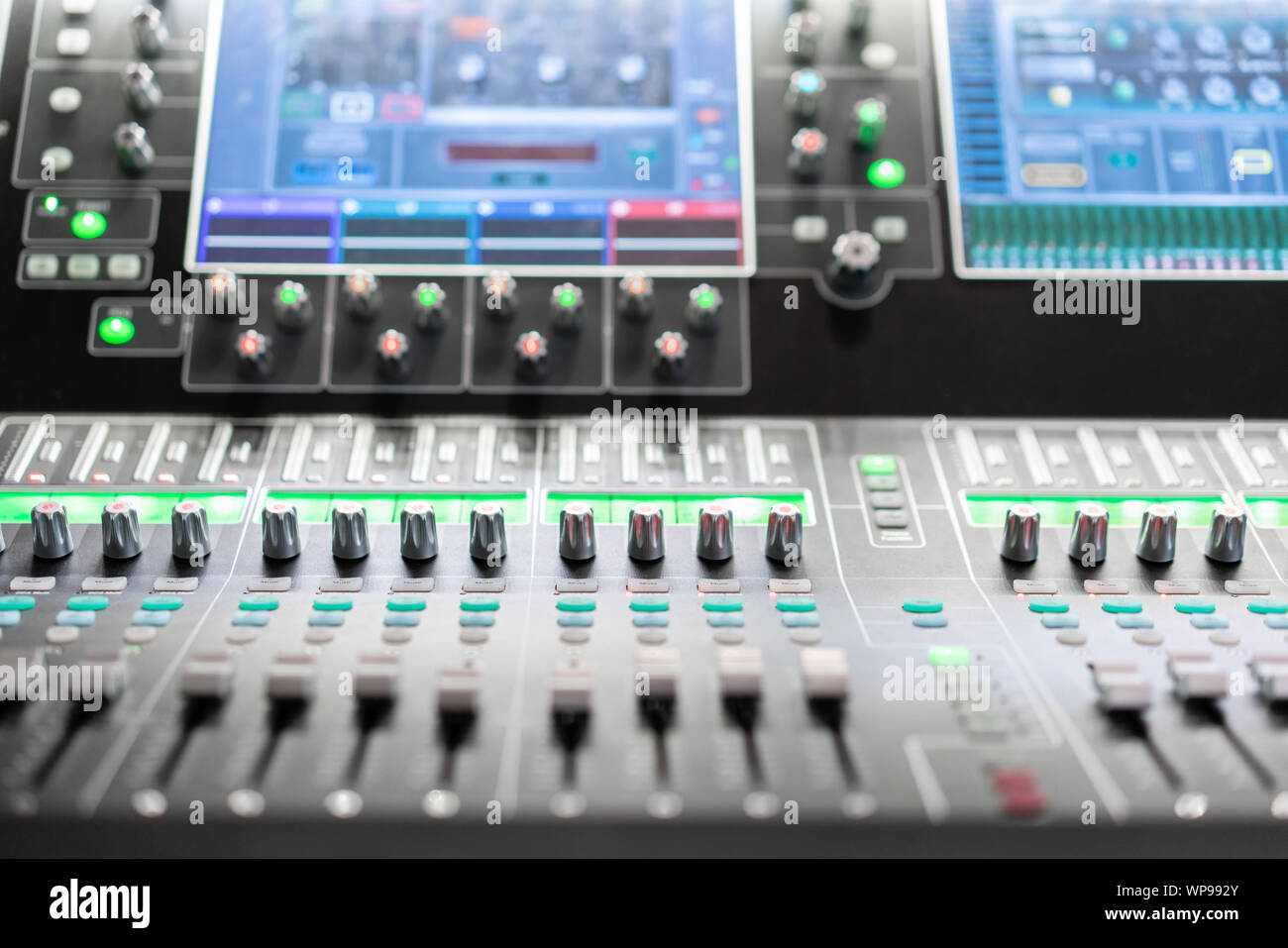 od adjusters and red buttons of a mixing console. It is used for audio ...