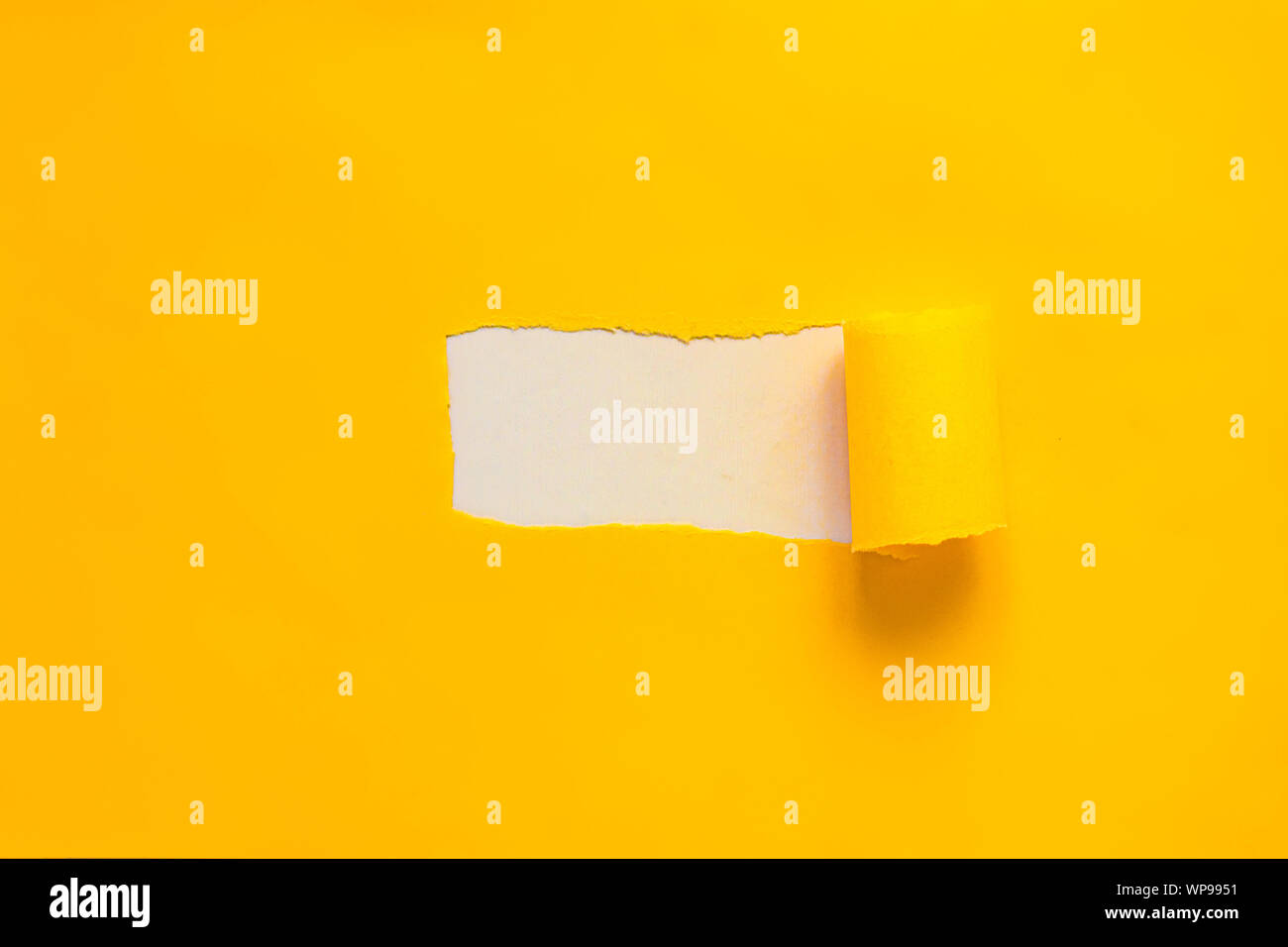 hole in a paper with torn side with a place for text, color surfaces ...