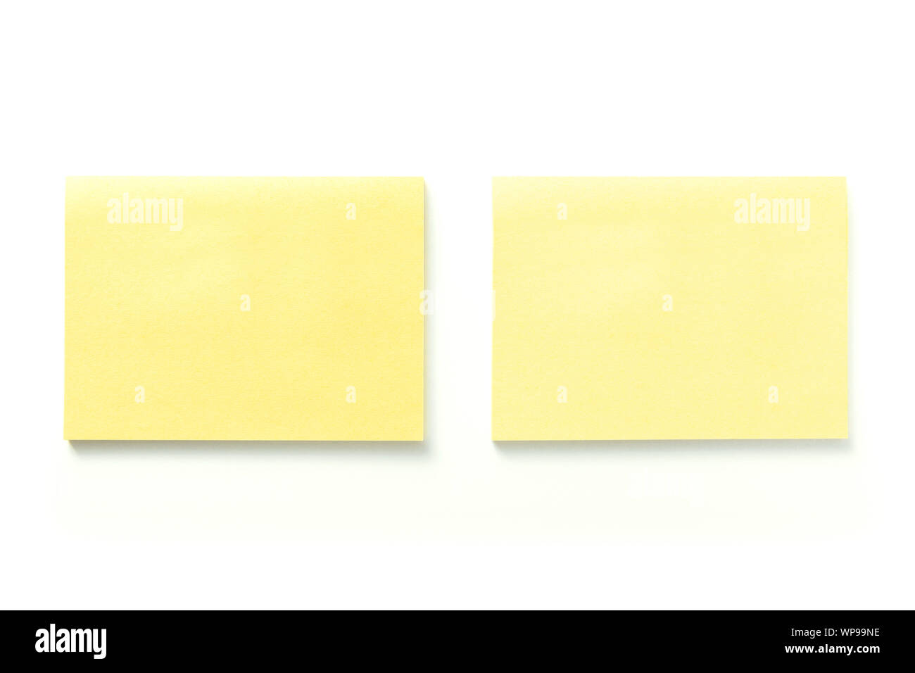 Two blank yellow sticky notes with shadow isolated on white background ...
