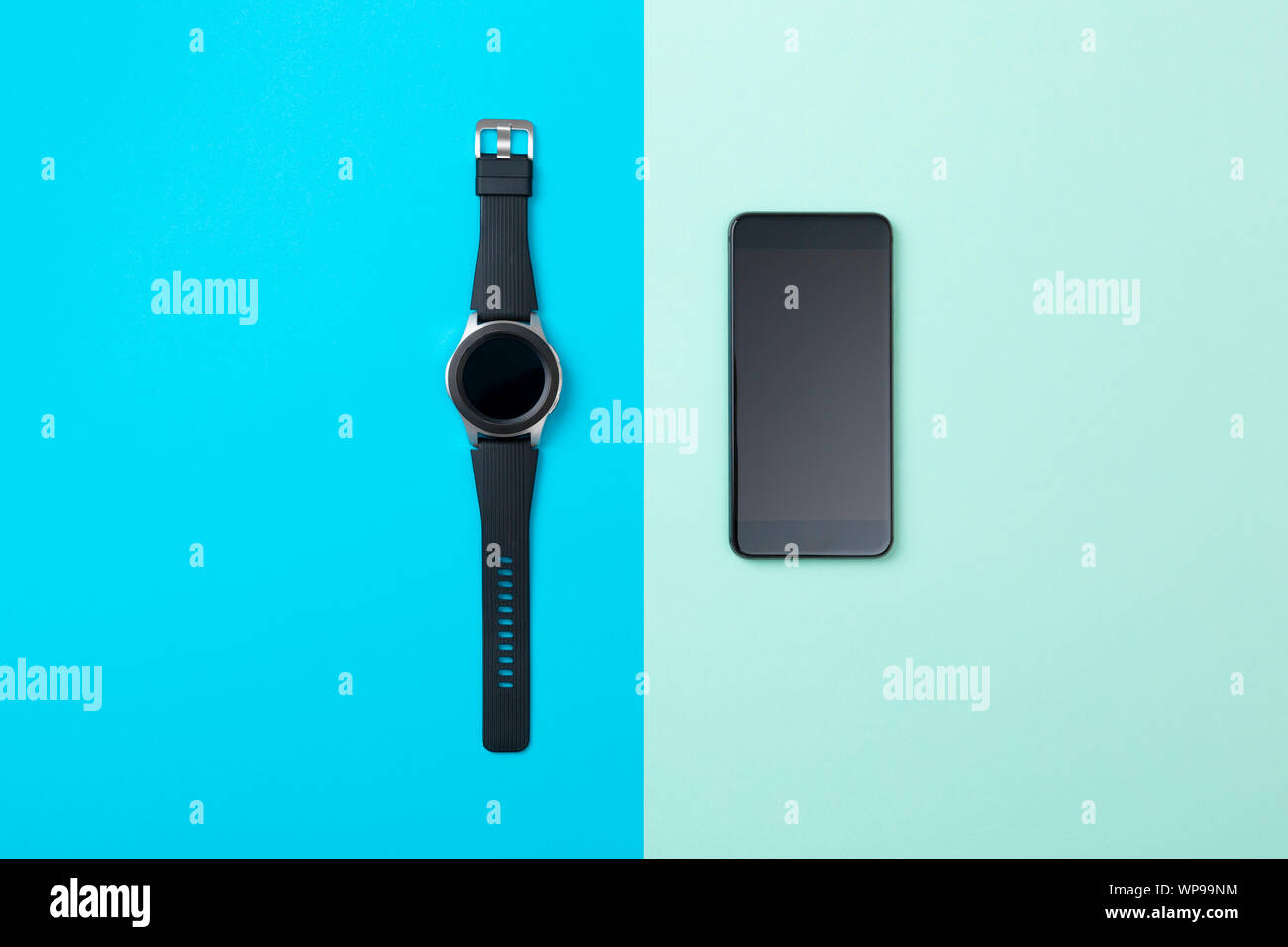 Top view of smartphone and smartwatch on light blue background Stock ...