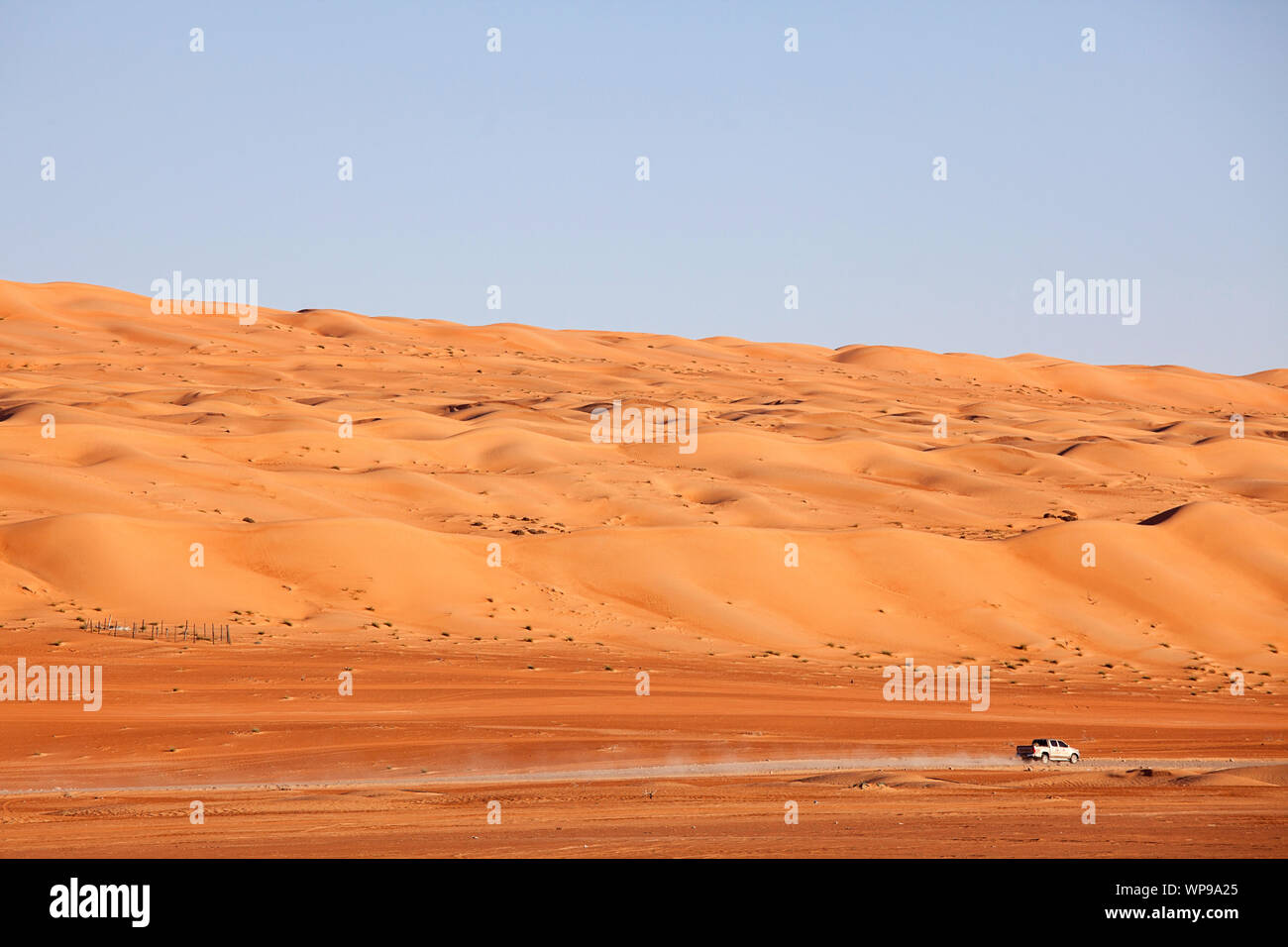 Car driving on desert road and dunes in Oman, Wahiba Sands Stock Photo ...