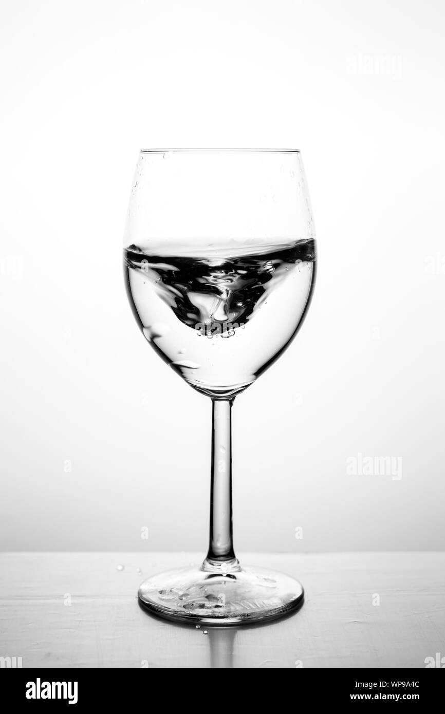 Glass with water up and splash Stock Photo - Alamy