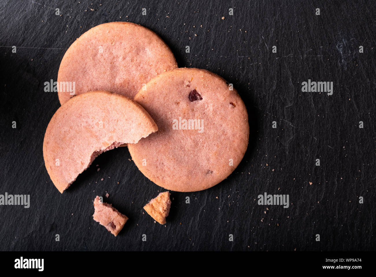 Sweet raspberry biscuits on a dark slate with crumbs - top view Stock ...