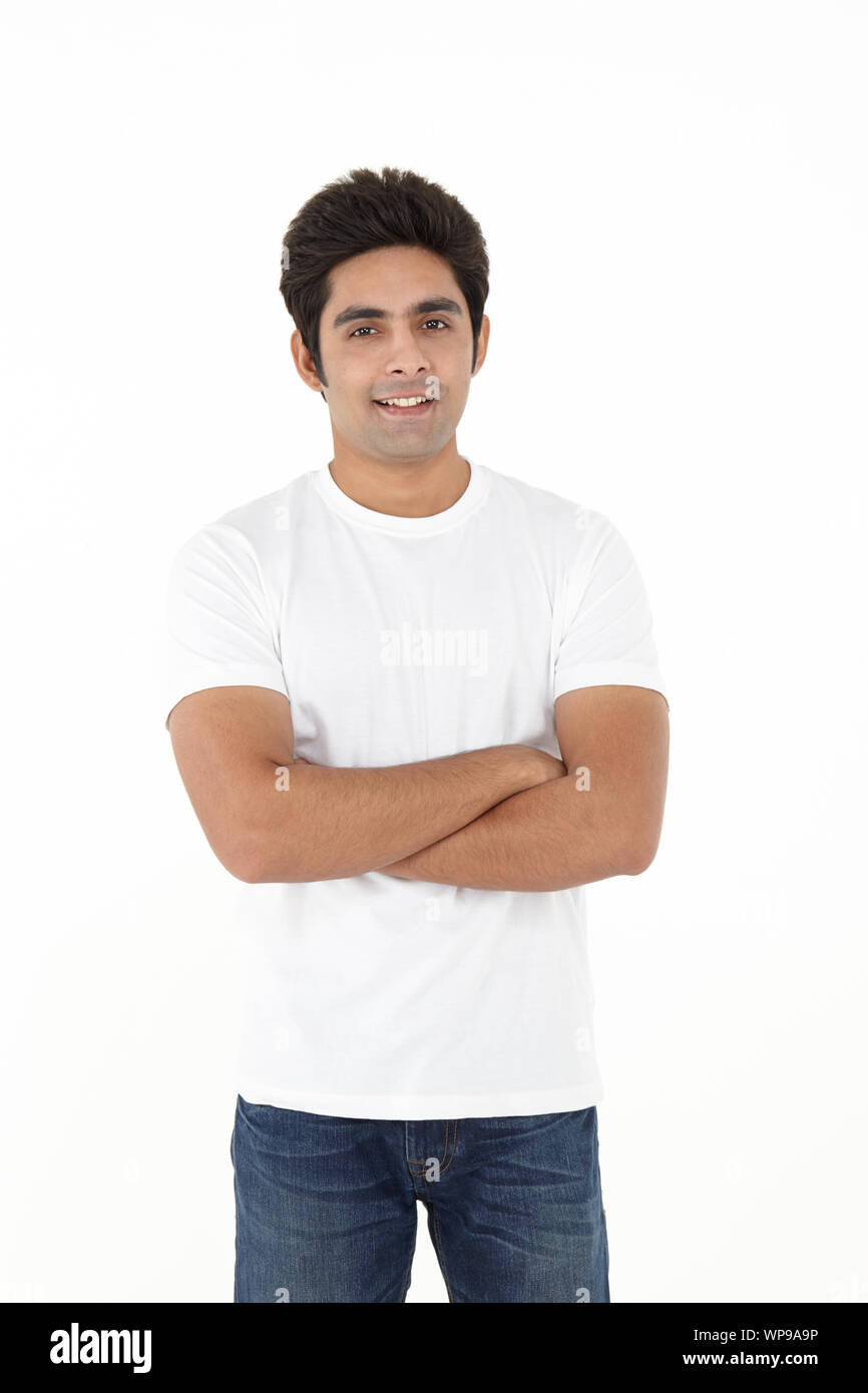 Young man smiling with his arms crossed Stock Photo - Alamy