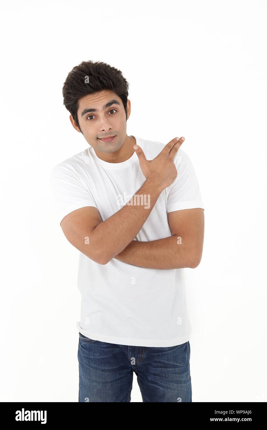 Young man making a gun sign Stock Photo - Alamy