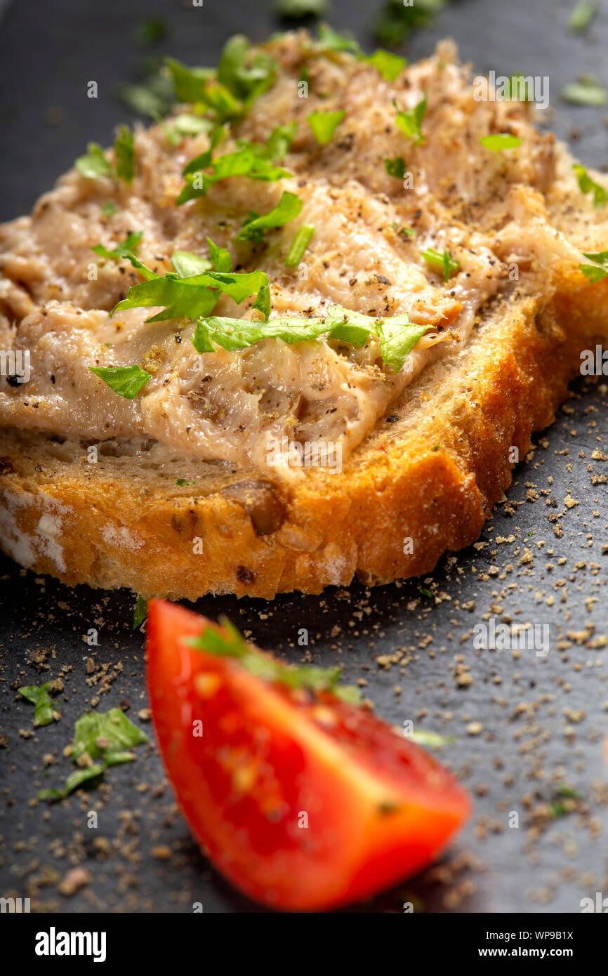 Bread with pork pate and ground black pepper on a dark slate Stock ...