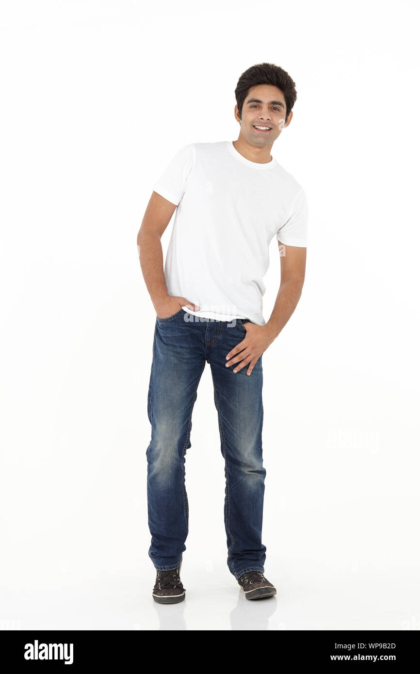 Smiling looking at camera standing hands in pockets hi-res stock ...