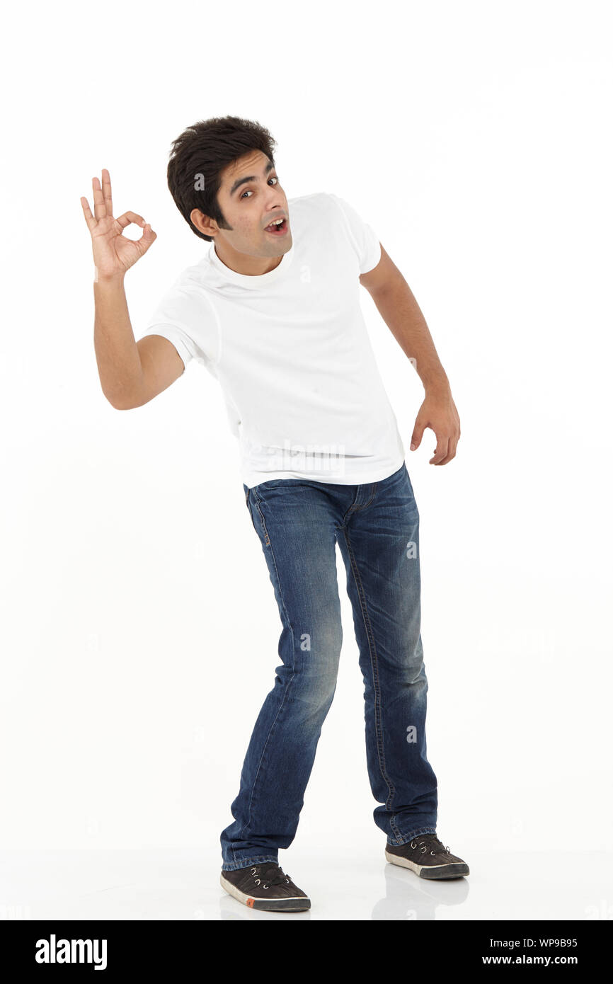 Young man showing OK sign Stock Photo - Alamy