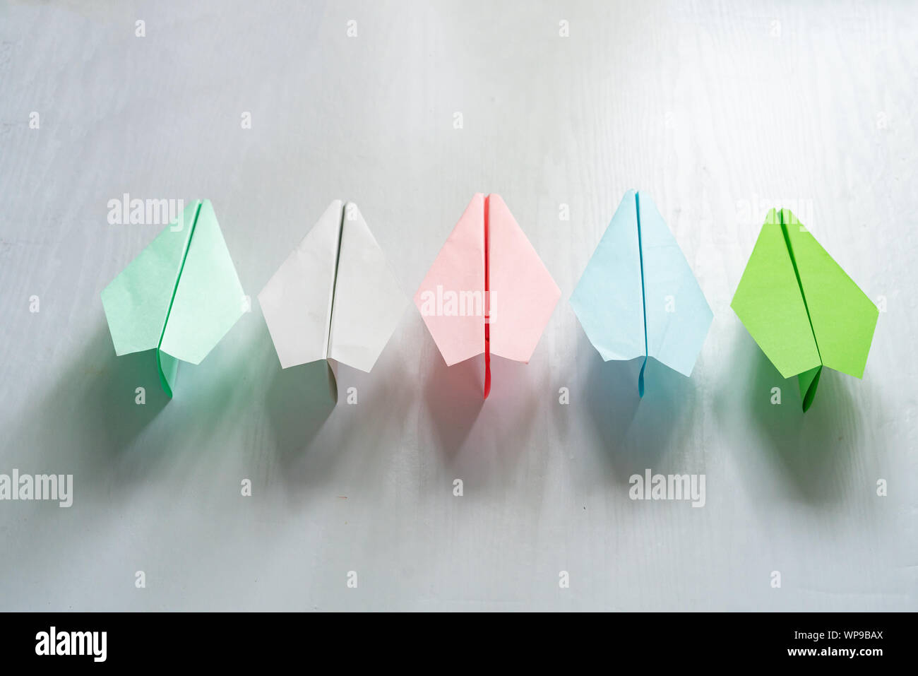 row of some color paper planes, handmade origami on the tables Stock ...