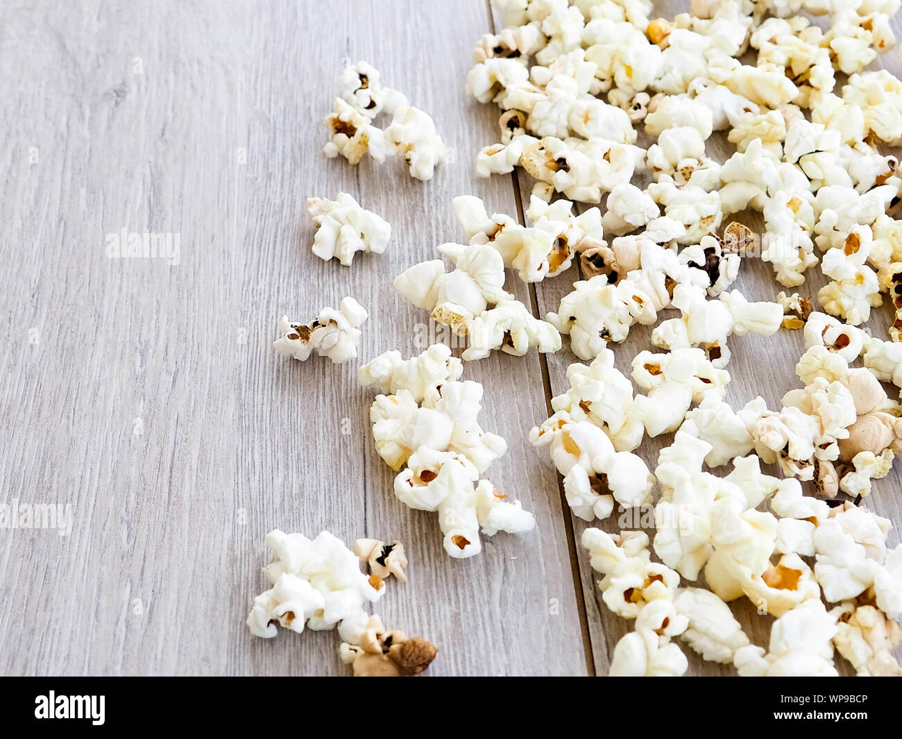 popcorn on wooden background, copy space. Scattered salted popcorn ...