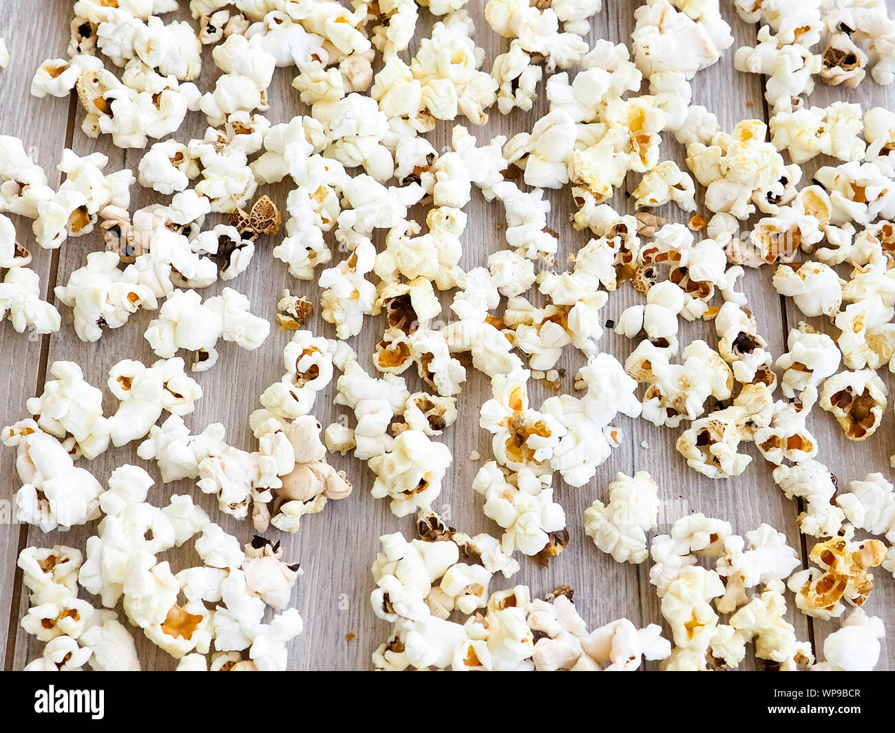 popcorn on wooden background, copy space. Scattered salted popcorn ...