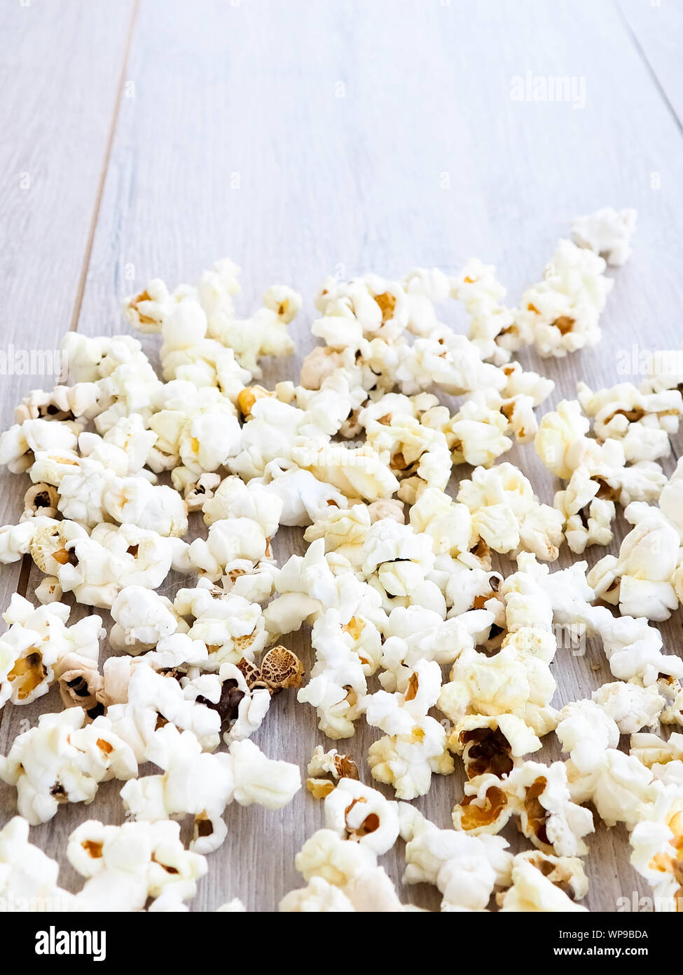 popcorn on wooden background, copy space. Scattered salted popcorn ...
