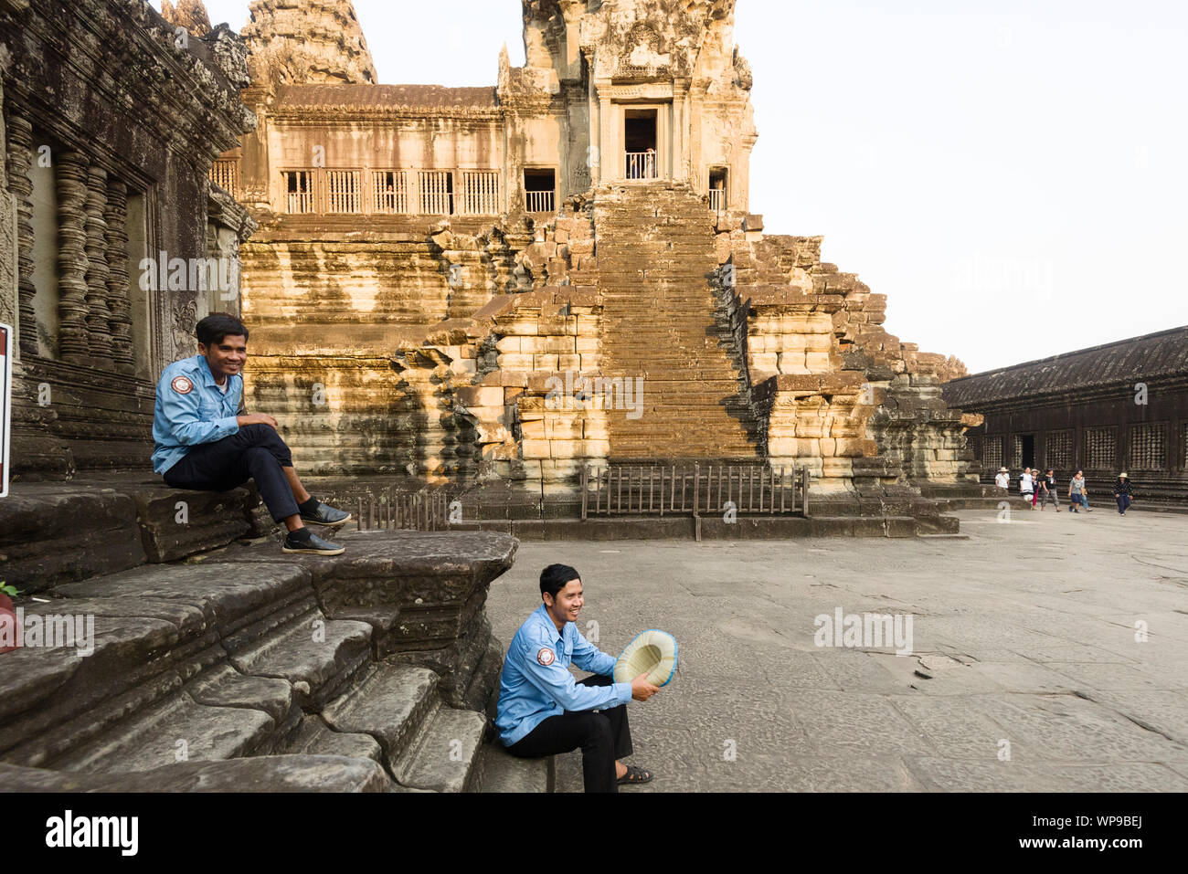 A tower of Angkor Wat and the guardians at the end of the day in Angkor ...