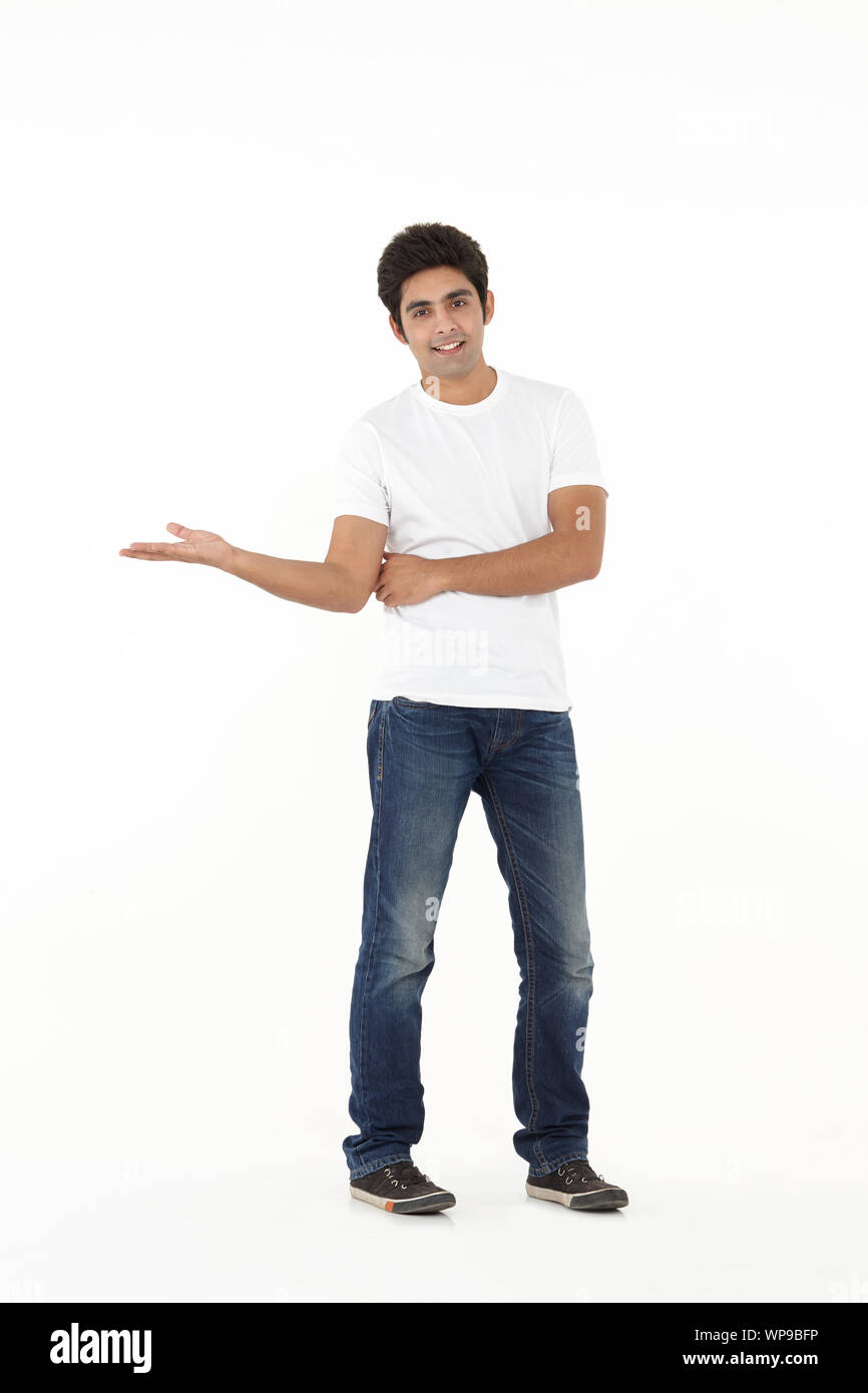 Young man showing empty palm Stock Photo - Alamy