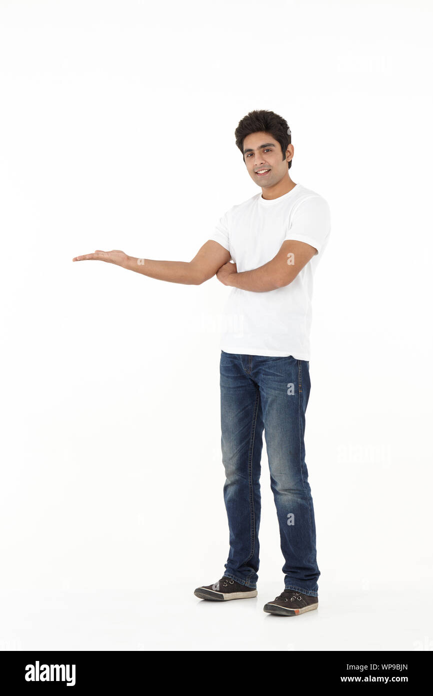 Young man showing empty palm Stock Photo - Alamy