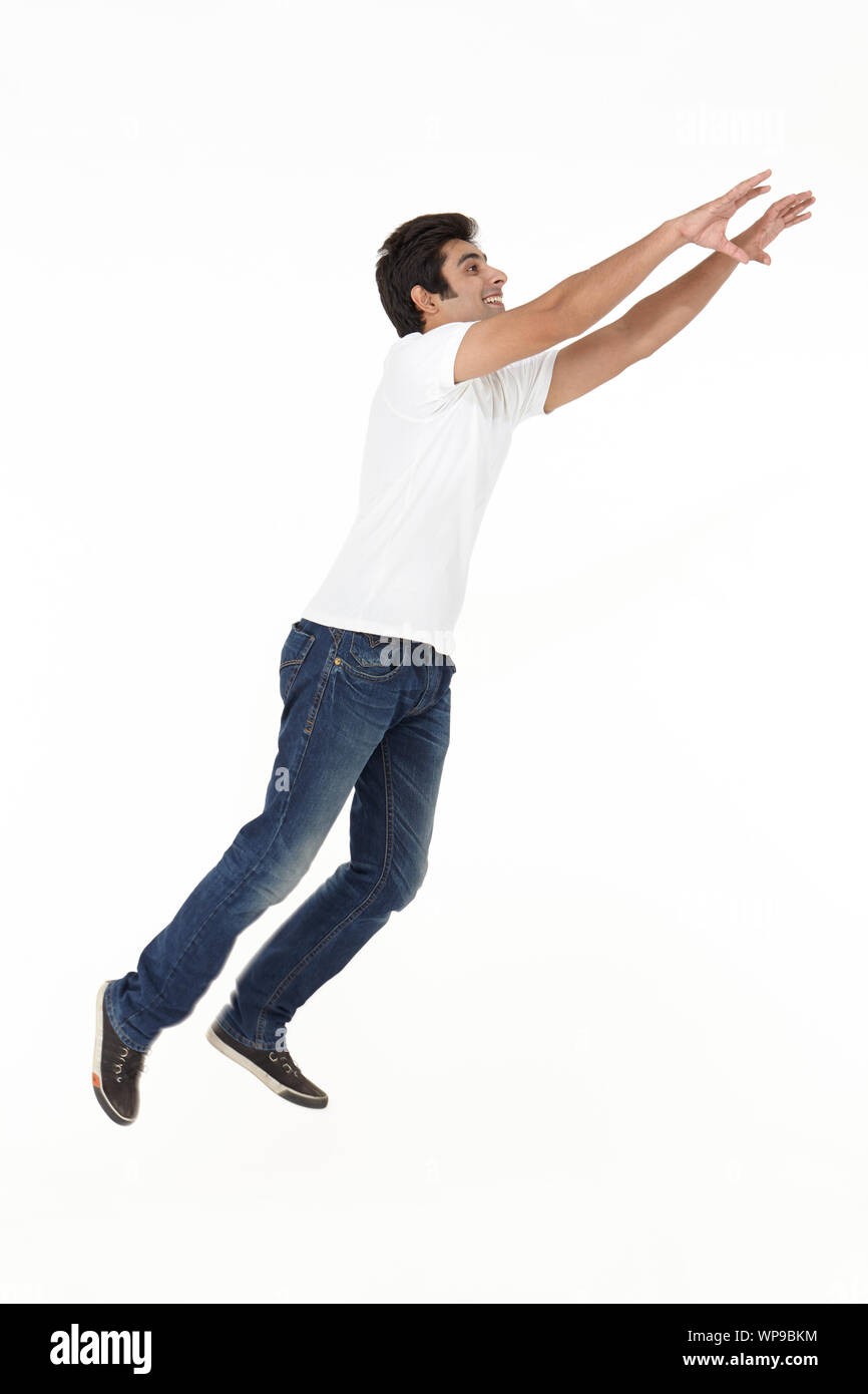 Young man jumping in air Stock Photo - Alamy
