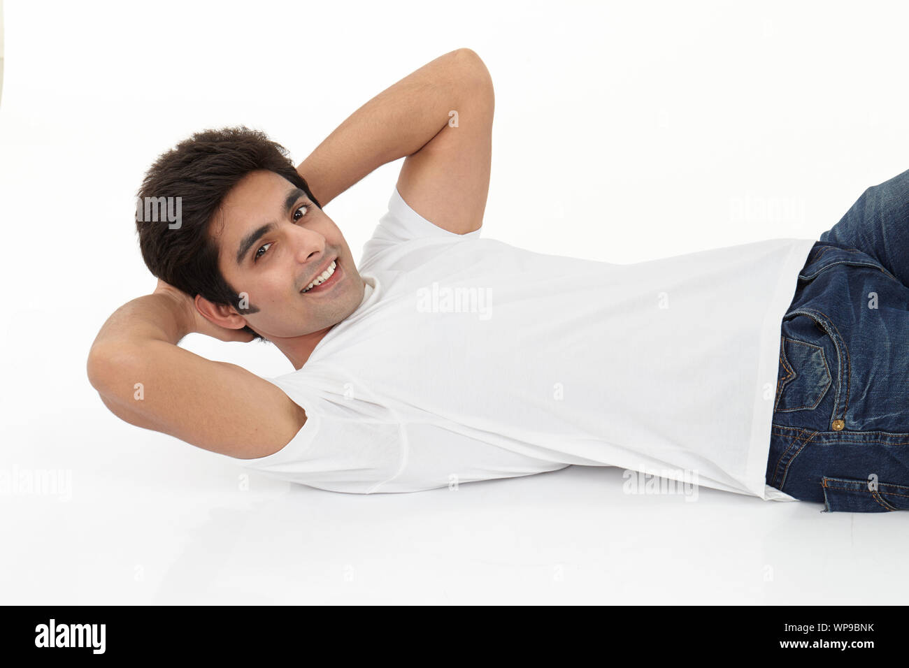 Young man lying on floor and smiling Stock Photo - Alamy